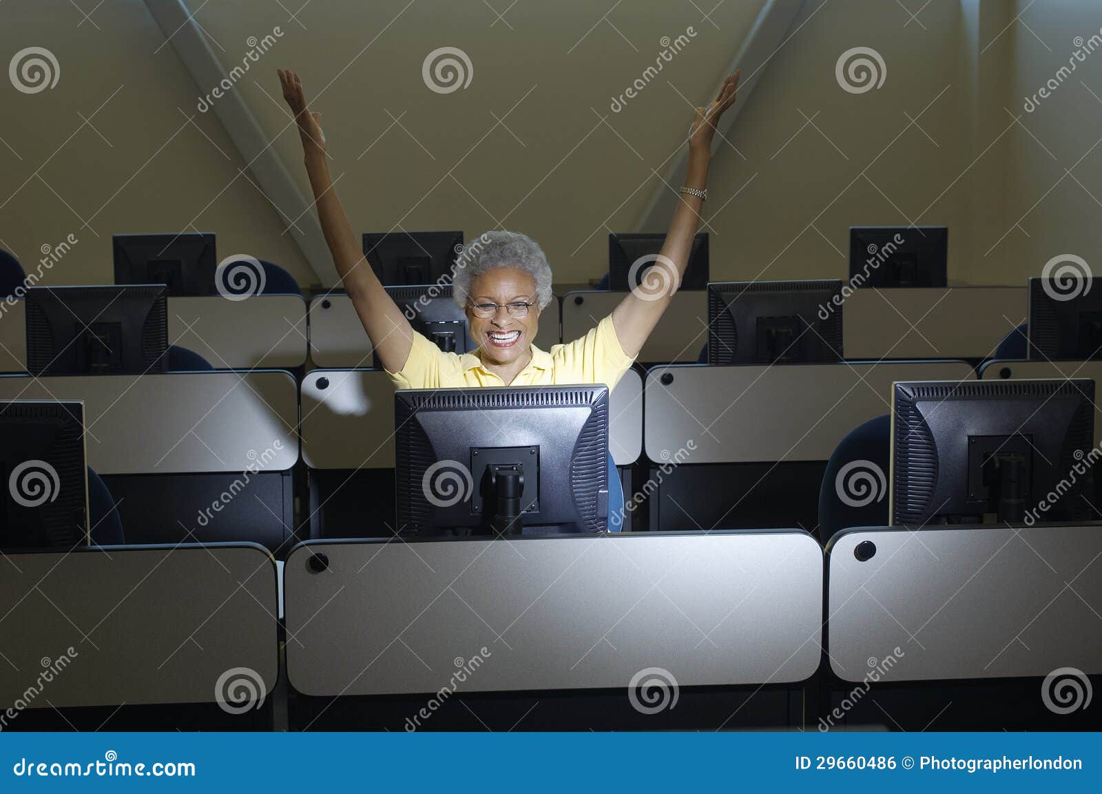 Female Professor Celebrating Victory in Computer Classroom Stock Photo ...