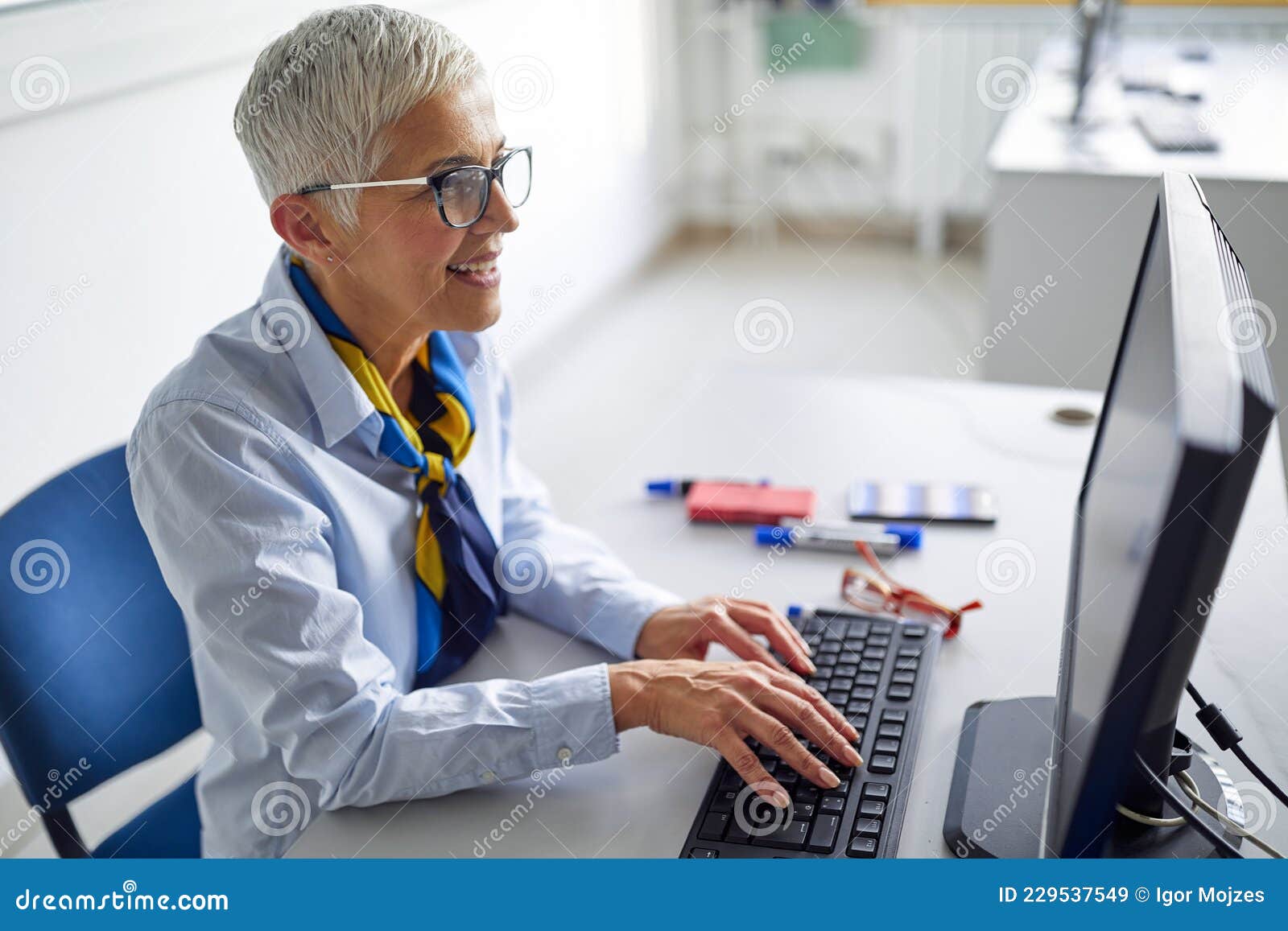 A Female Professor in Front of a Computer Desk at the Informatics ...