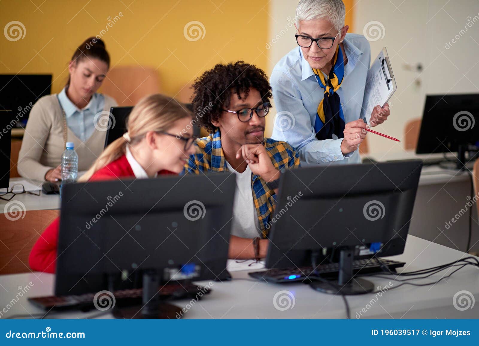Female Professor Helping Students at an Informatics Lecture Stock Image ...