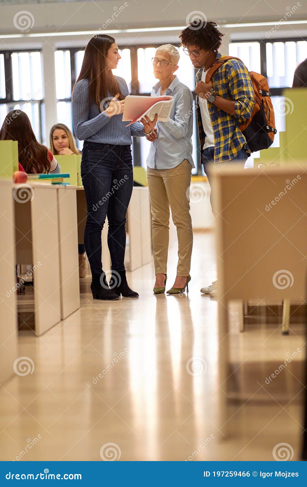 Female Professor Helping Students about the Lesson Stock Photo - Image ...