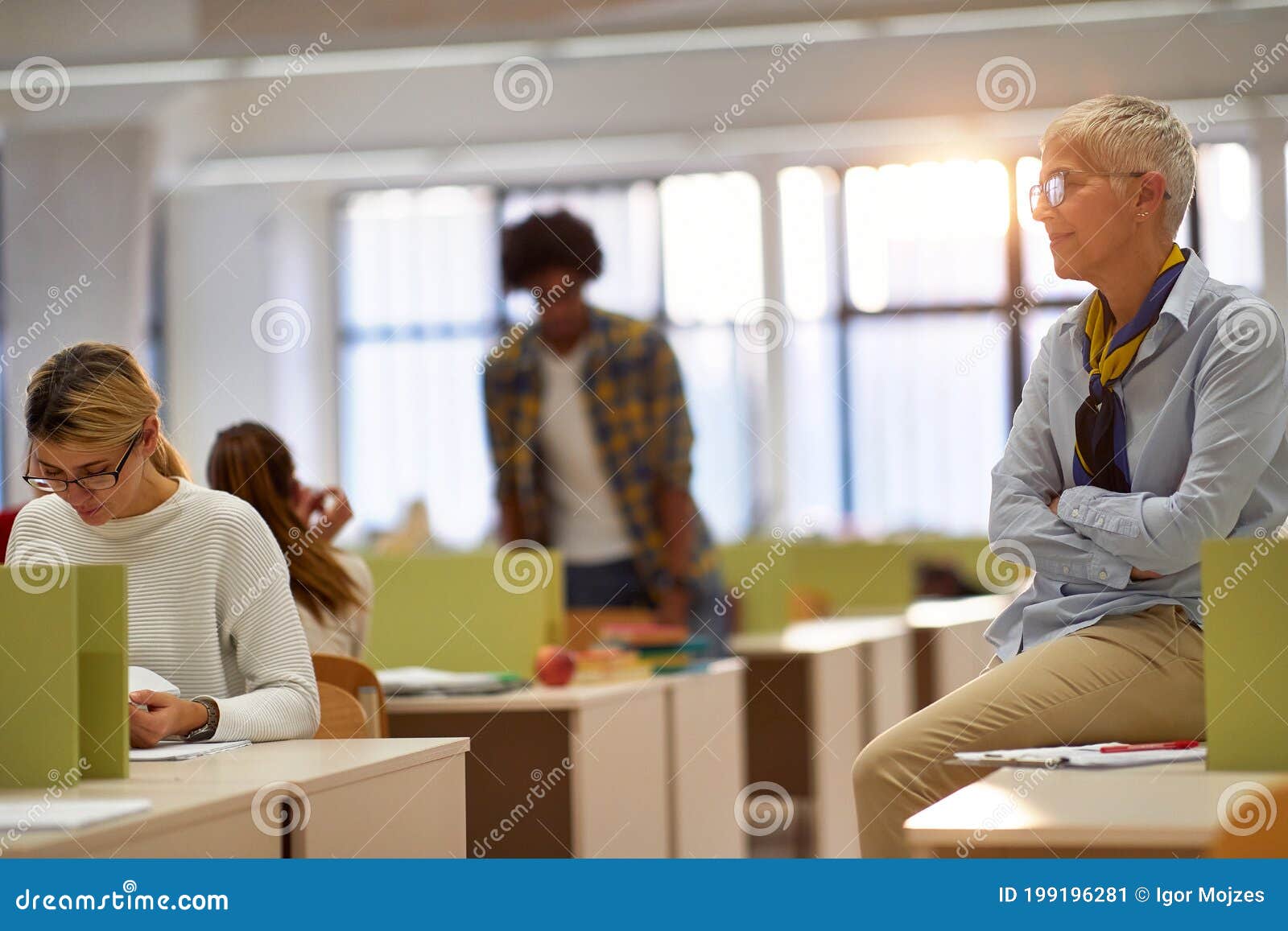 Female Professor Observing Students Work. Smart Young People Study at ...