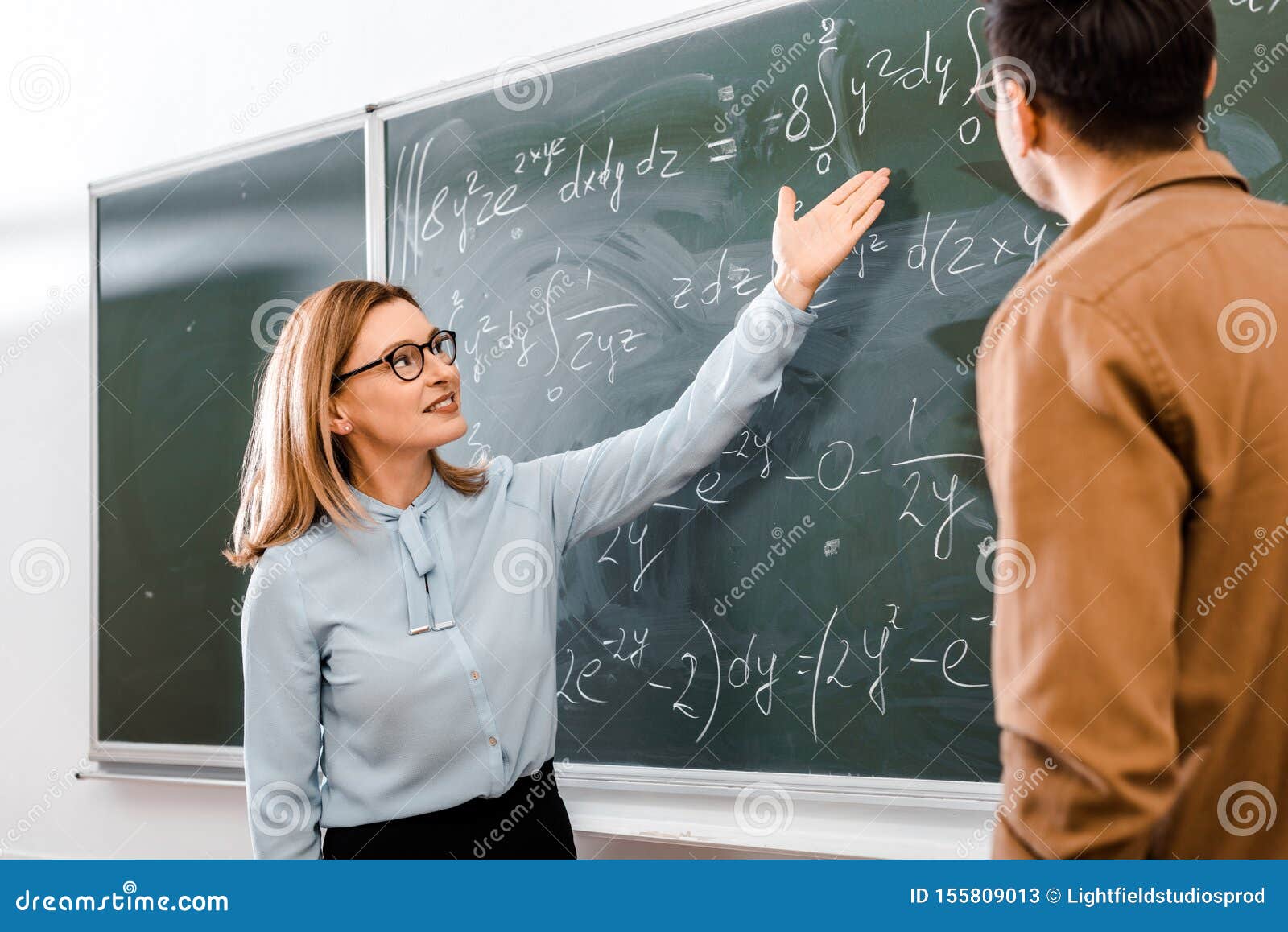 Female Professor Showing Equations Stock Image - Image of caucasian ...