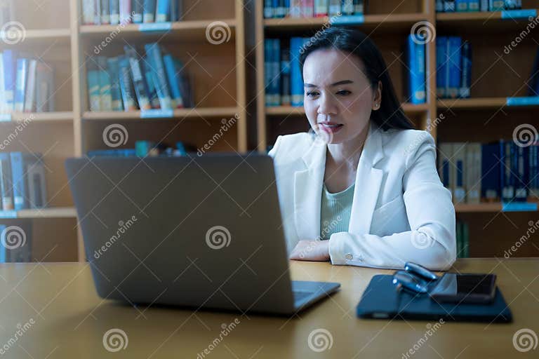 Female Professor Teaching an Online Class at the Library Stock Photo ...