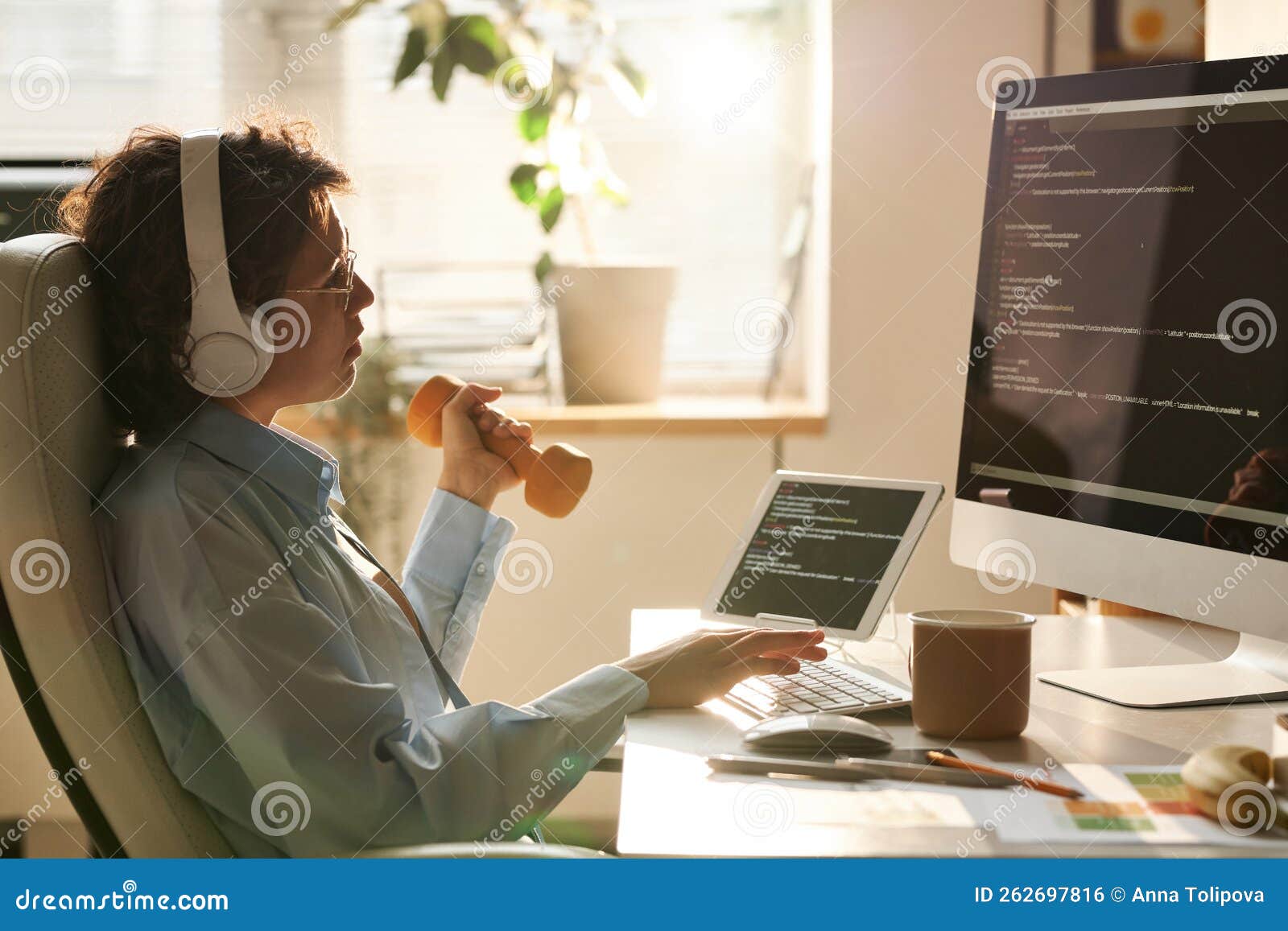 Female Programmer Exercising with Dumbbells at Her Workplace Stock ...