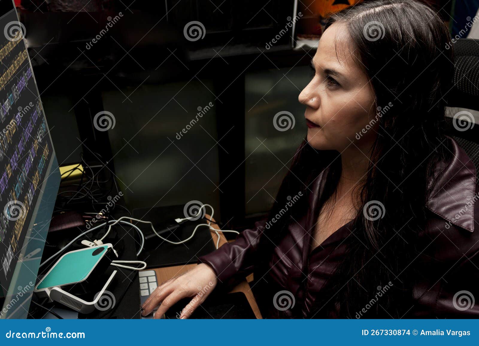 Female Programmer Working In Front Of Computer Sitting At Desk Works And Writes Codes And