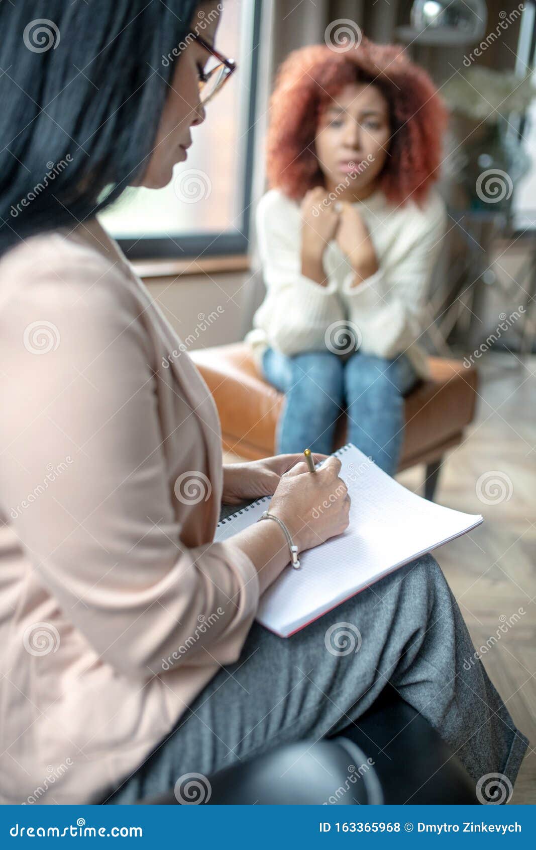 Female Psychoanalyst Feeling Attentive while Making Notes Stock Photo ...