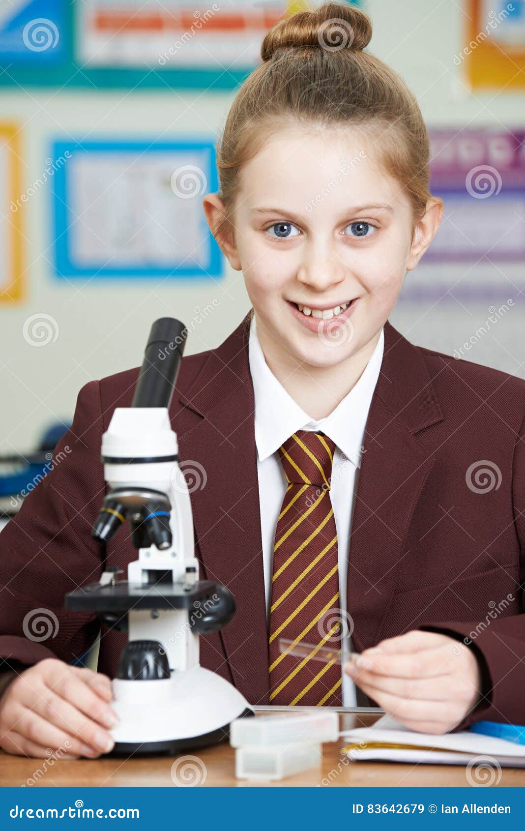 Female Pupil Using Microscope in Science Lesson Stock Image - Image of ...