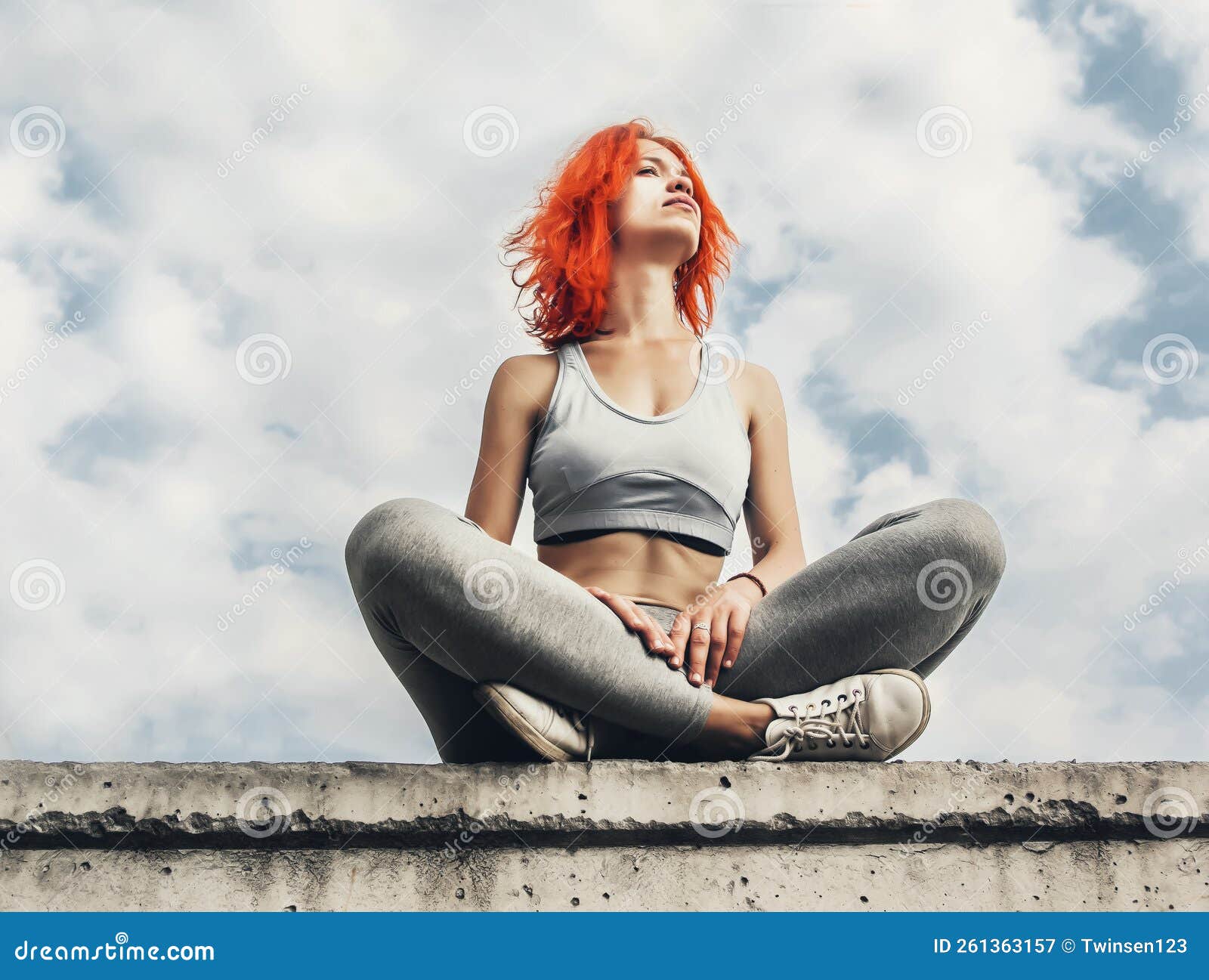 Female Racer Seated on a Panel Isolated on Sky Background Stock Image ...