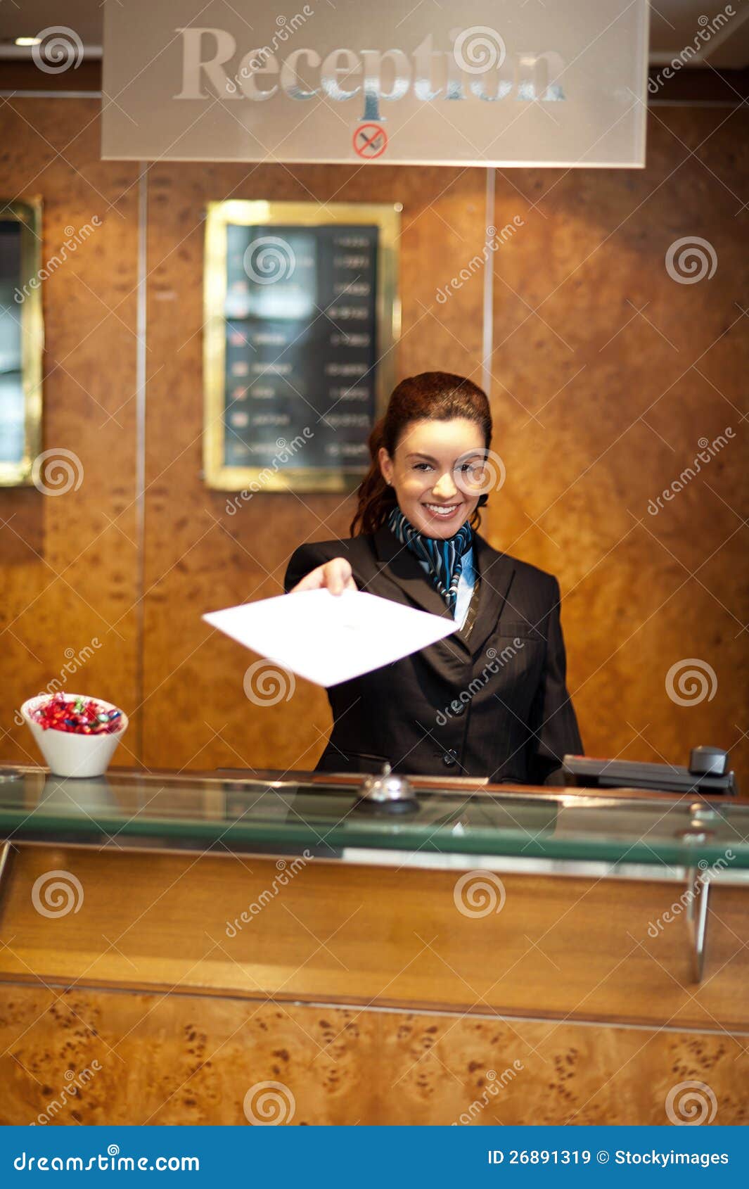 Female Receptionist Handing Over Check-out Papers Stock Image - Image ...