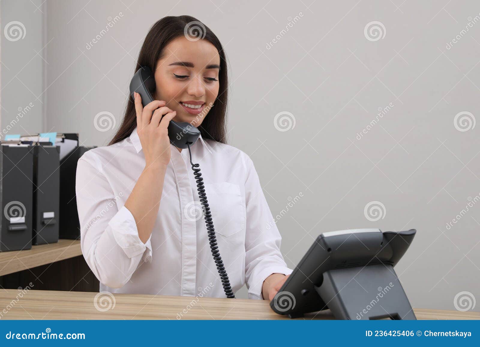 Female Receptionist Talking on Phone at Workplace Stock Photo - Image ...