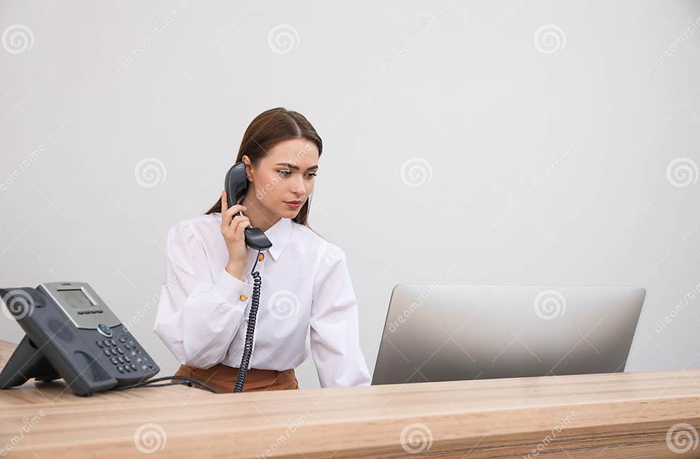 Female Receptionist Talking on Phone at Workplace Stock Image - Image ...