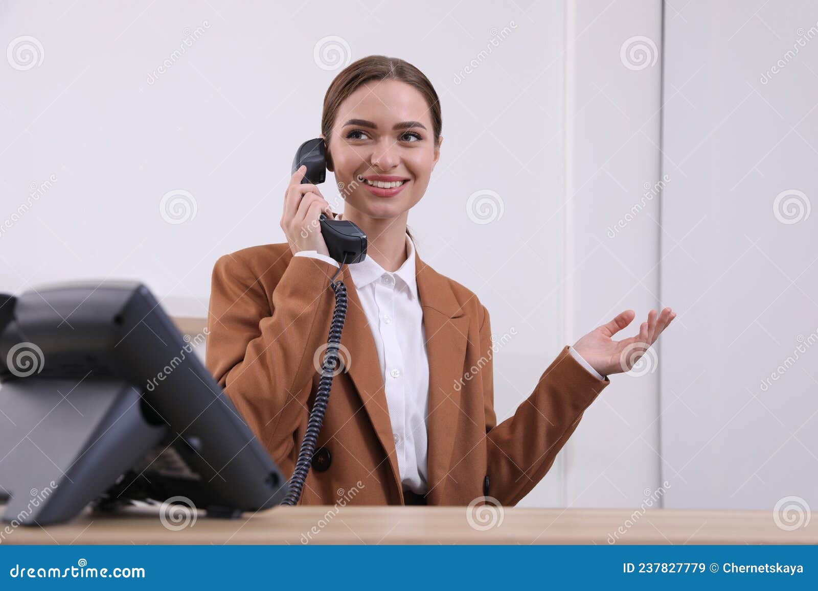 Female Receptionist Talking on Phone at Workplace Stock Image - Image ...