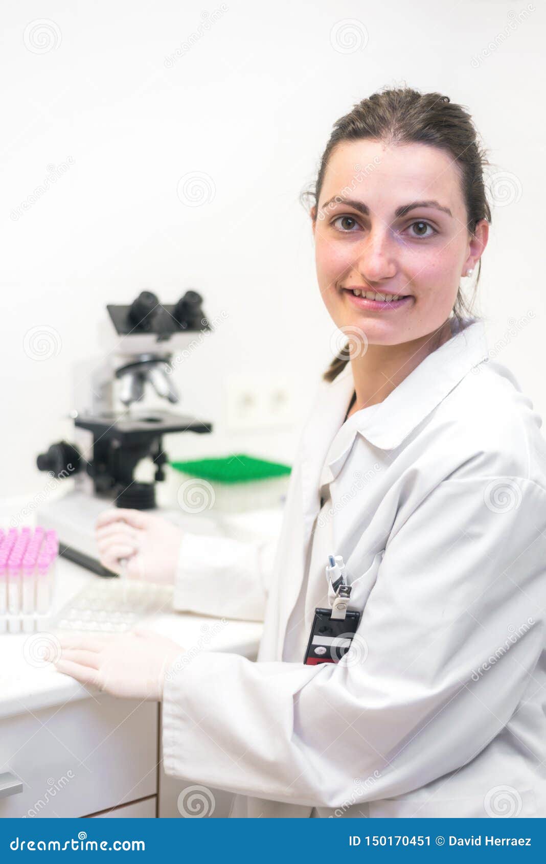Female Researcher Smiling. Female Researcher Using Microscope and ...