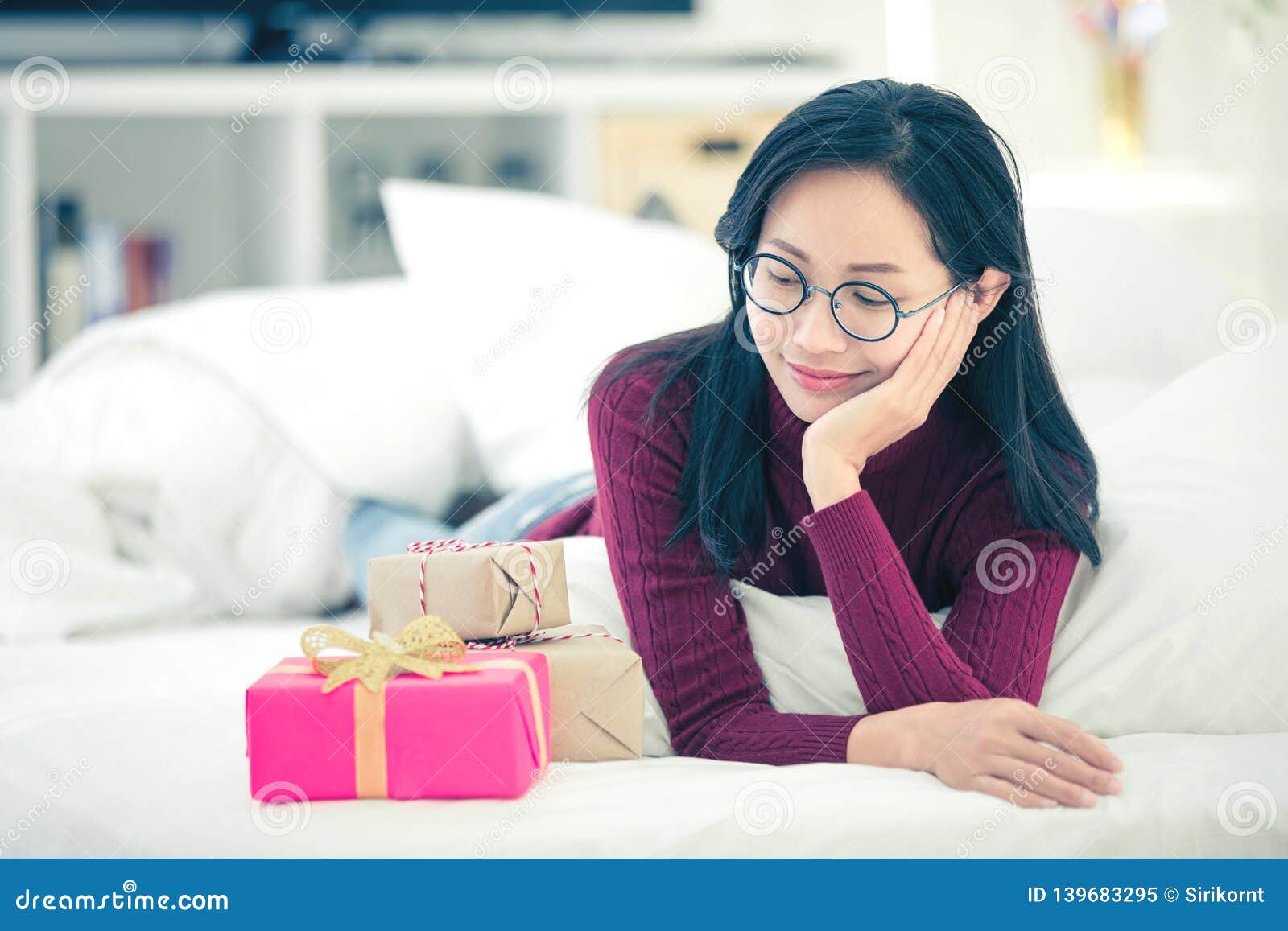 Female Rest on Bed and Looking Gift Box with Smile Face Stock Image ...