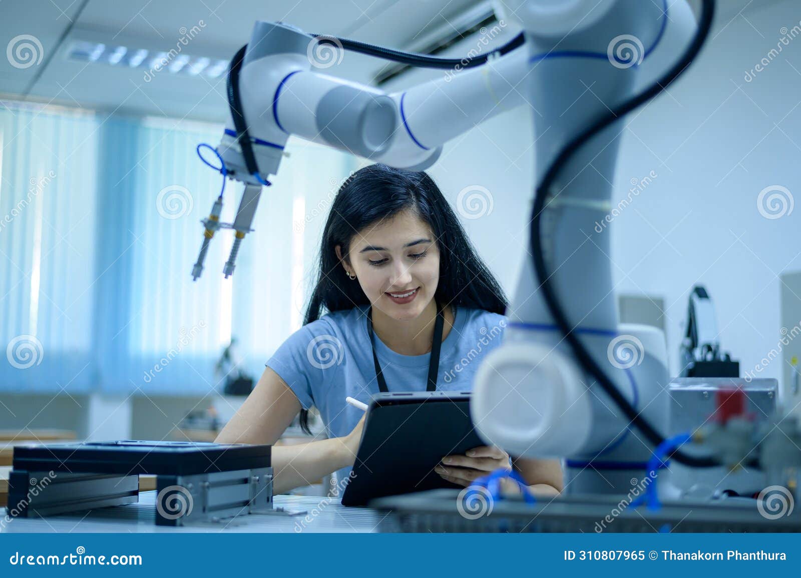 Female Robotics Engineer Working with Programming and Manipulating ...