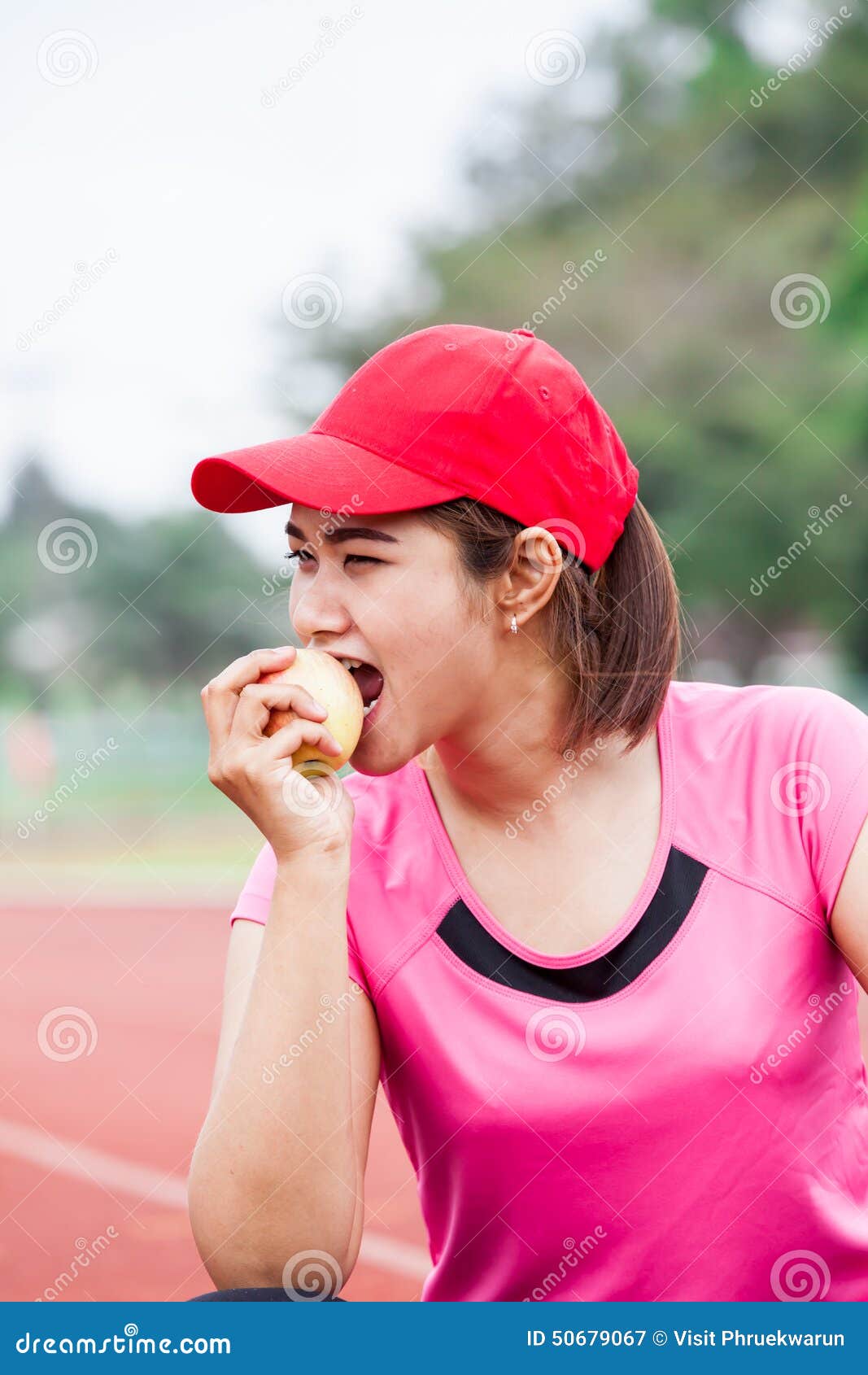 Female runner eating apple stock image. Image of food - 50679067