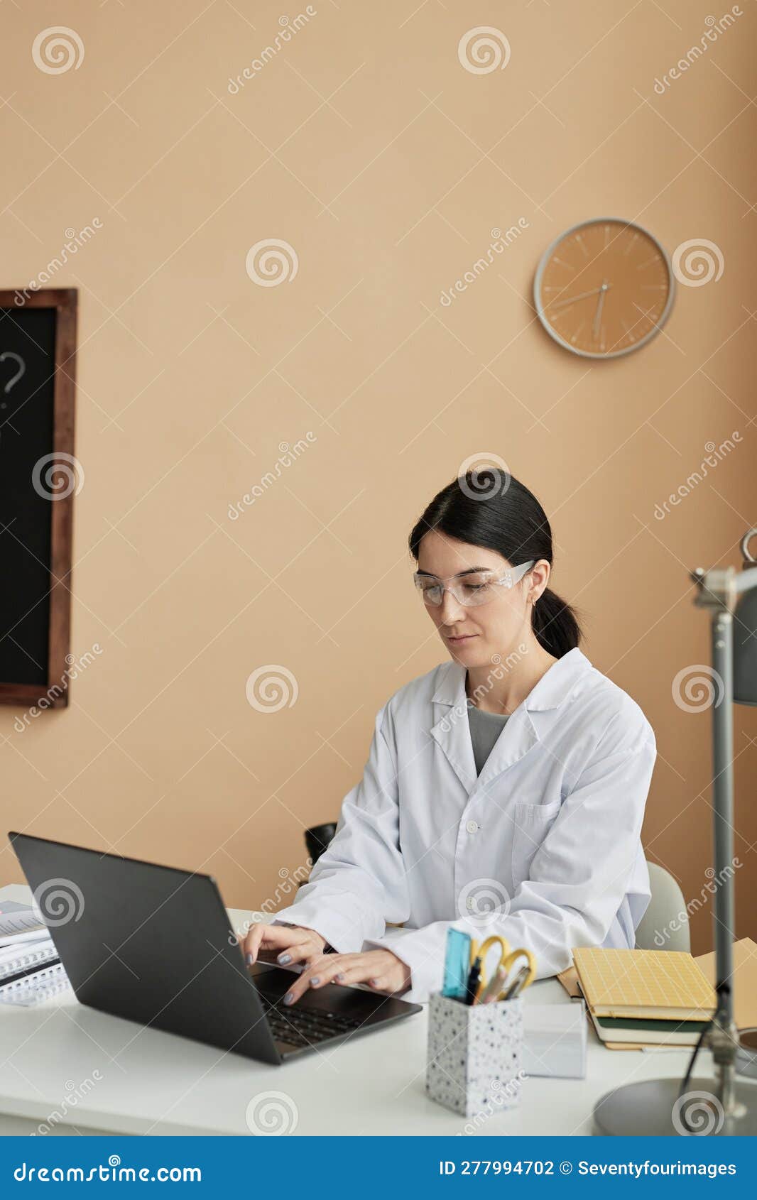 Female Science Class Teacher Using Laptop in Classroom Above Stock ...