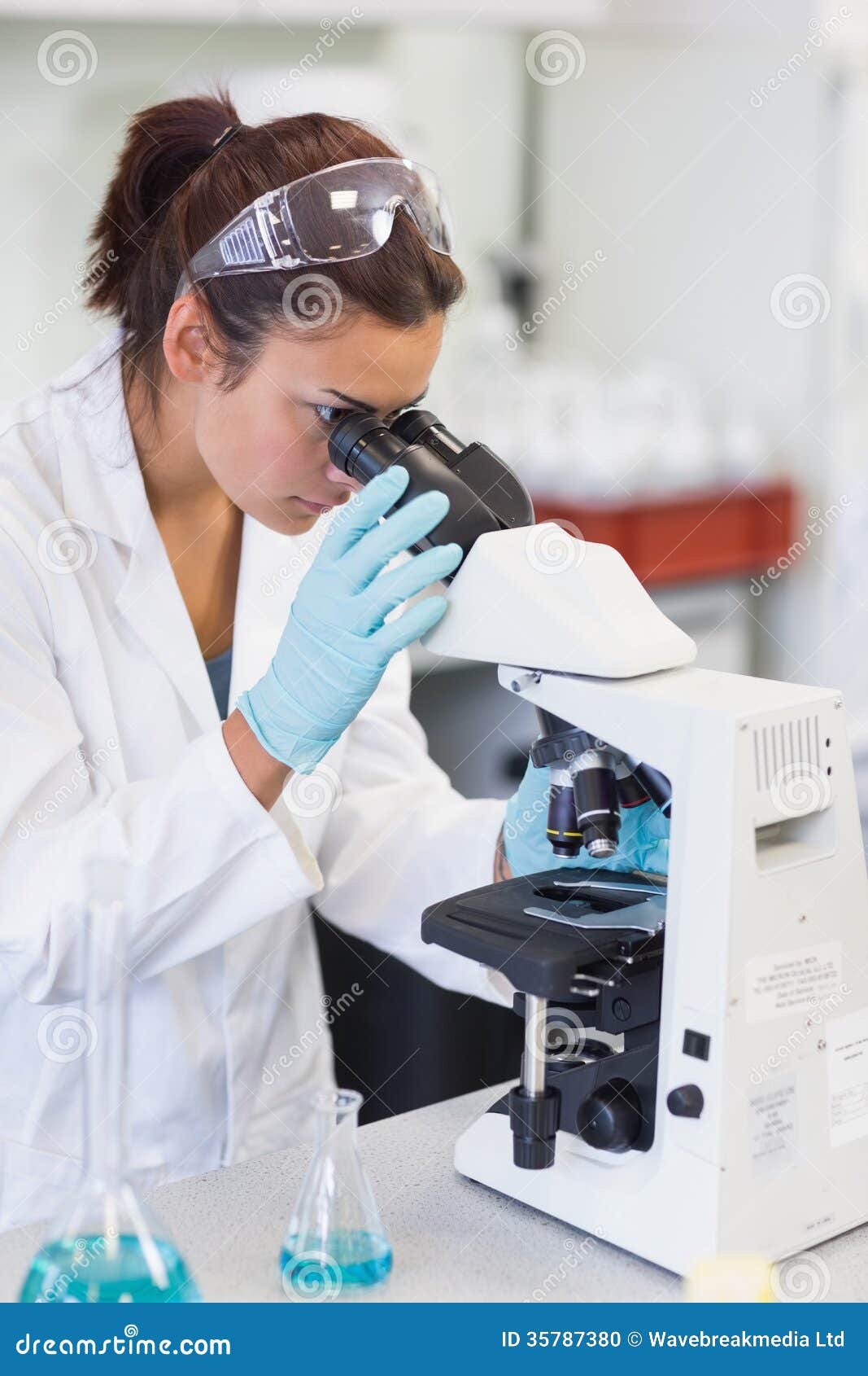 Female Scientific Researcher Using Microscope in Lab Stock Photo ...