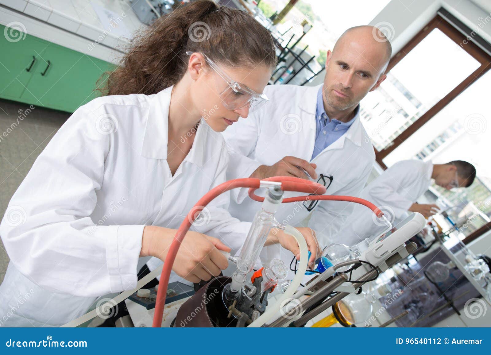 Female Scientist Analysing Something through Microscope in Laboratory ...