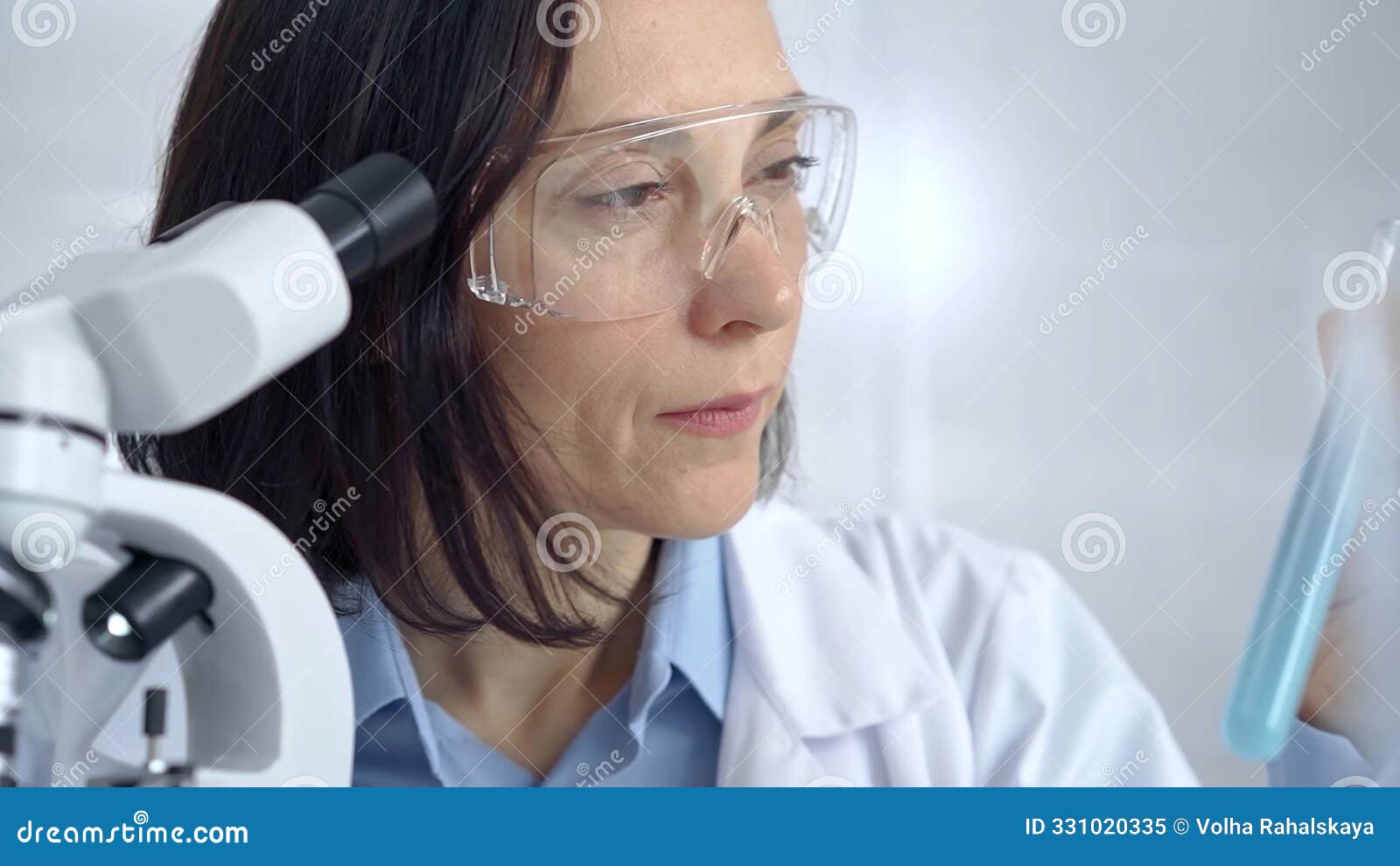 Female Scientist Analyzing Sample of a Test Tub in Laboratory Setting ...