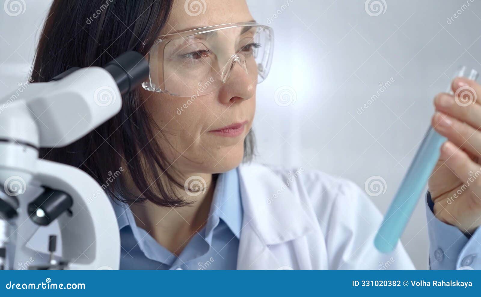 Female Scientist Analyzing Sample of a Test Tub in Laboratory Setting ...