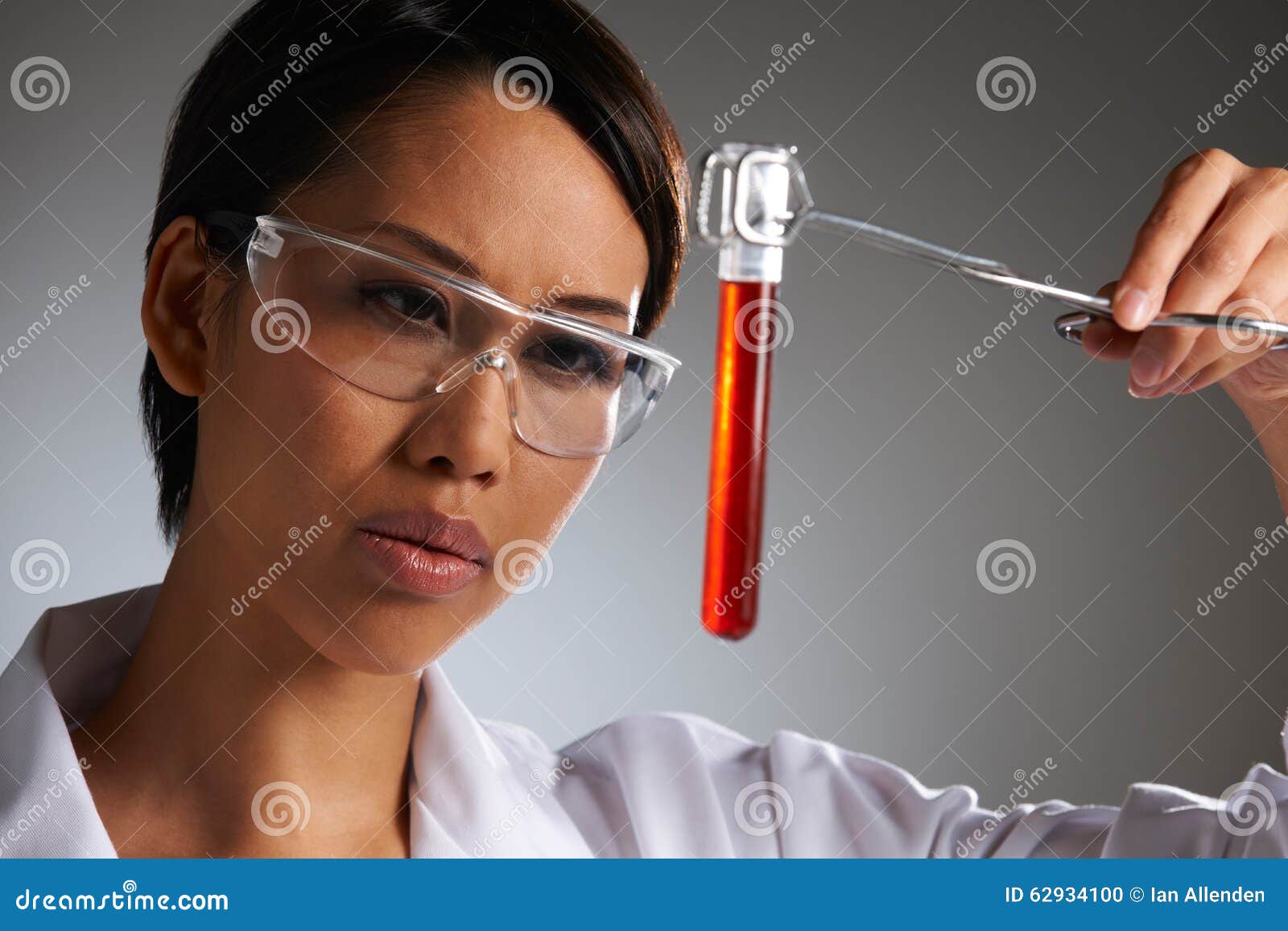 Female Scientist Examining Test Tube Stock Photo - Image of studio ...