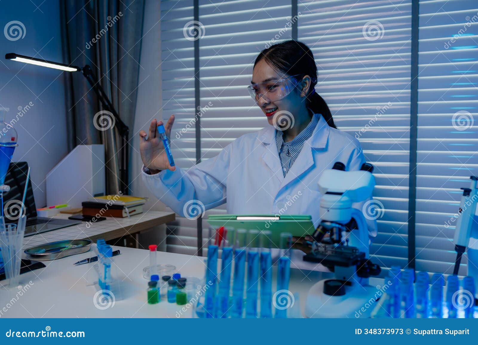 A Female Scientist is Experimenting with Chemicals in a Lab, Science ...