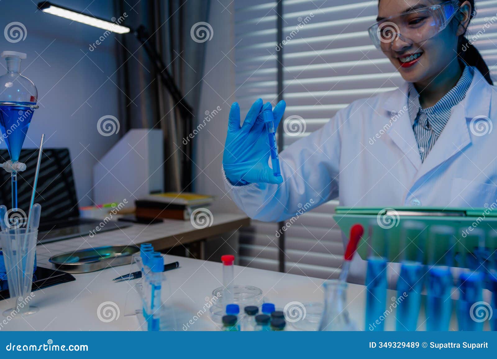 A Female Scientist is Experimenting with Chemicals in a Lab, Science ...