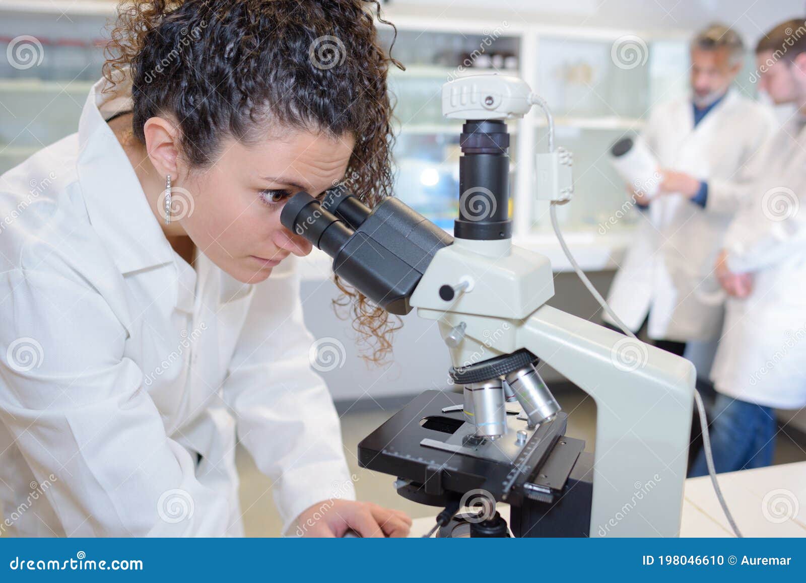 Female Scientist Looking into Microscope Stock Photo - Image of ...