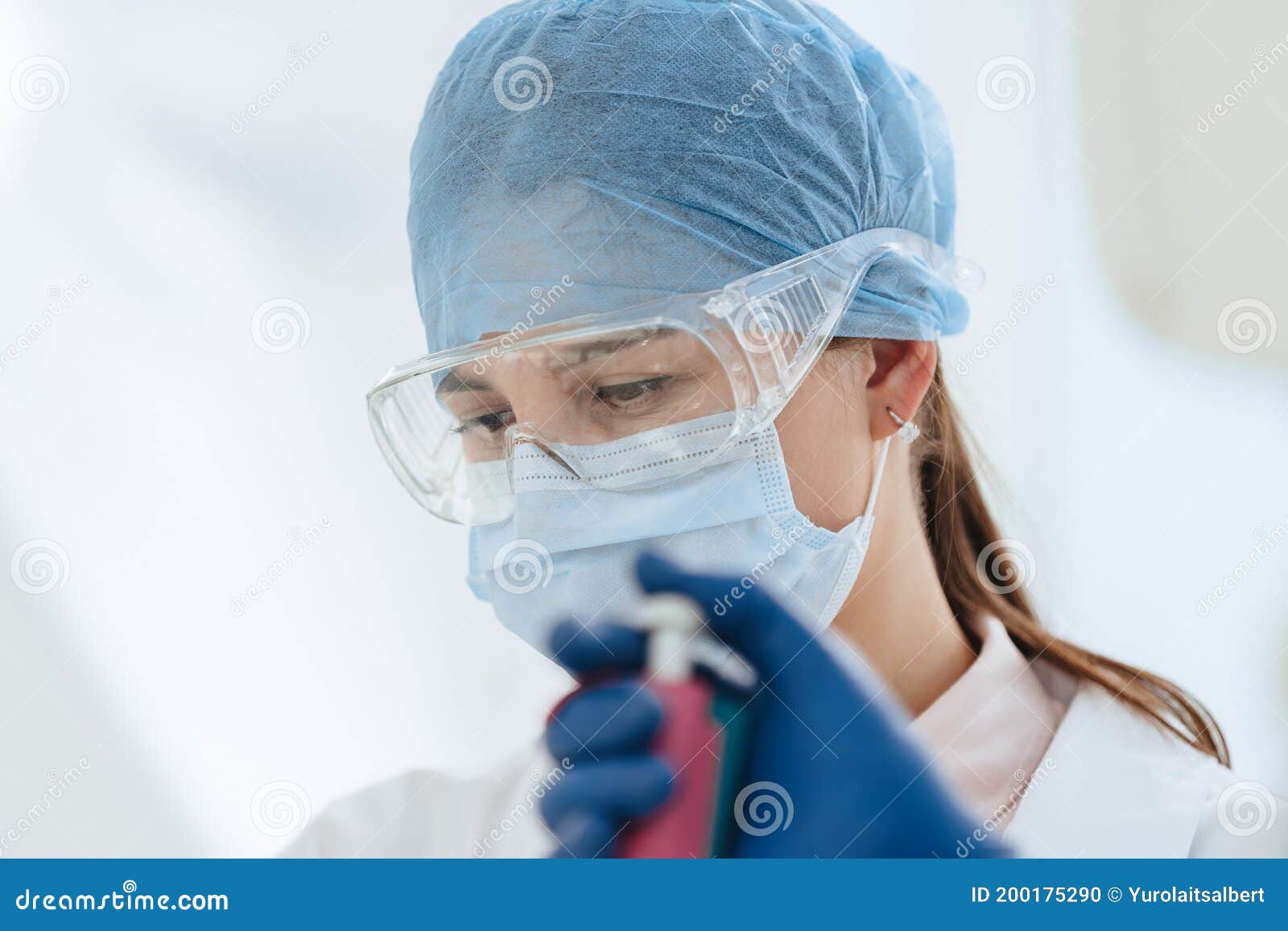 Female Scientist in a Protective Mask Works in a Laboratory. Stock ...