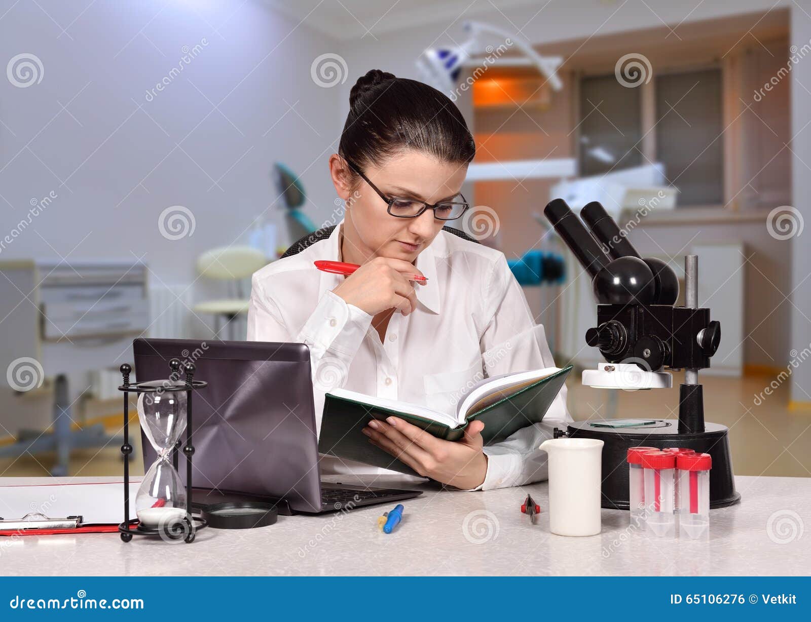 Female Scientist Reading a Book Sitting Stock Photo - Image of micro ...