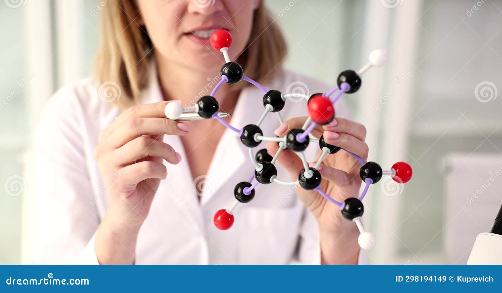 Female Scientist Shows Model of Molecular Structure in Laboratory Stock ...