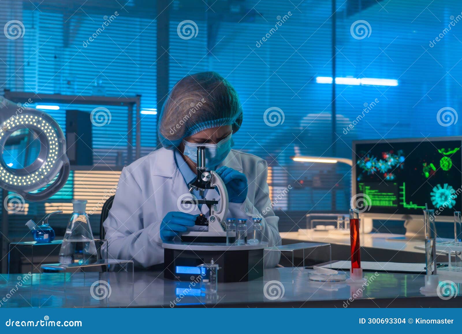 Female Scientist Sitting in a Research Lab with Test Tubes and Flasks ...