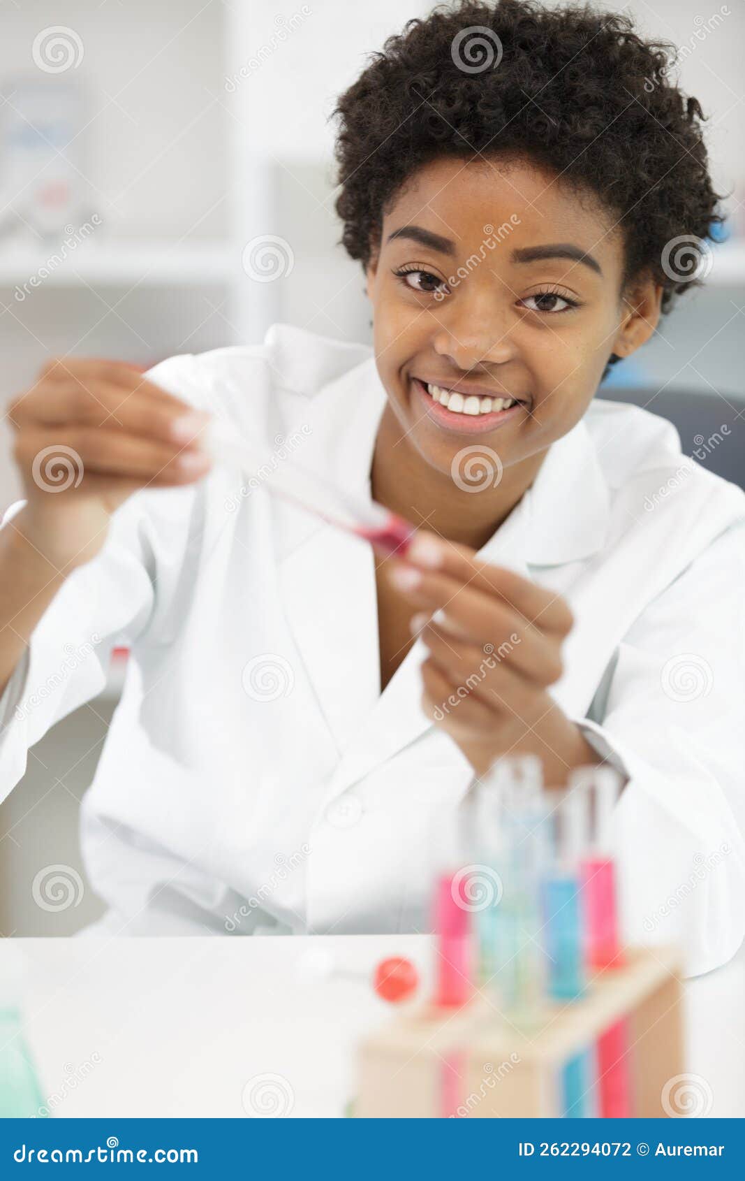 Female Scientist Smiling with Test Tube in Hands Stock Photo - Image of ...