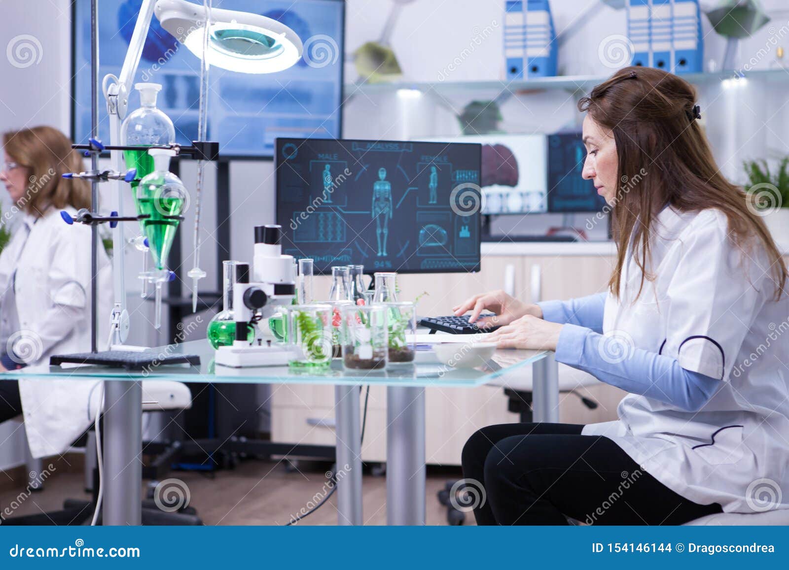 Female Scientist Typing on Her Computer the Data from Last Scientific ...