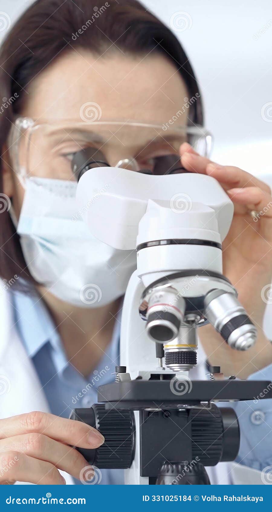 Female Scientist Using Microscope in Laboratory. Focus on a Woman in ...