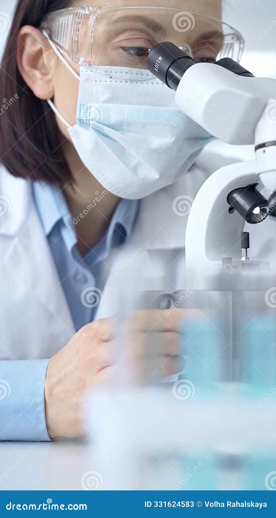 Female Scientist Using Microscope in Laboratory. Focus on a Woman in ...