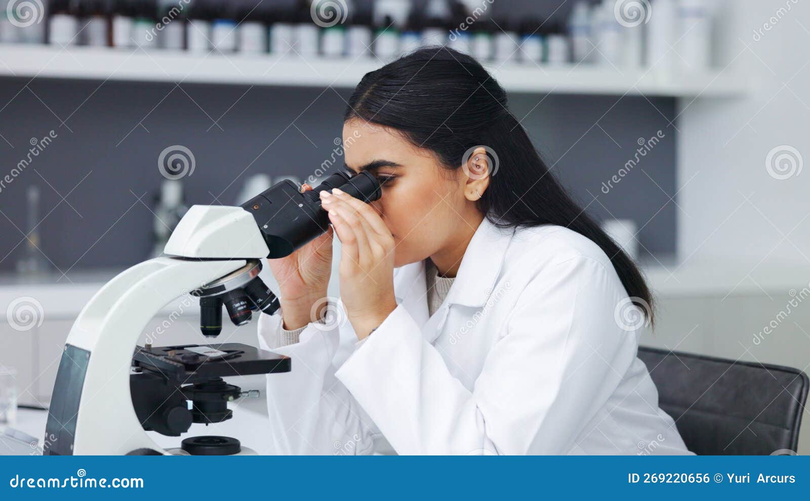 Female Scientist Using a Microscope in a Research Lab. Young Biologist ...