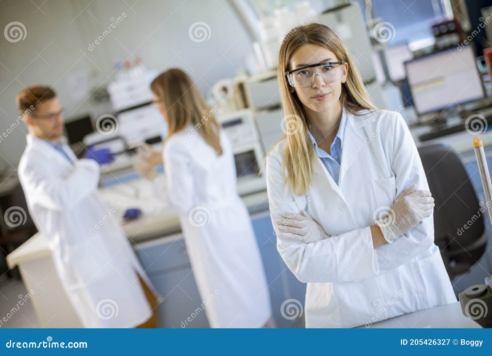Female Scientist in White Lab Coat Standing in the Biomedical Lab Stock ...