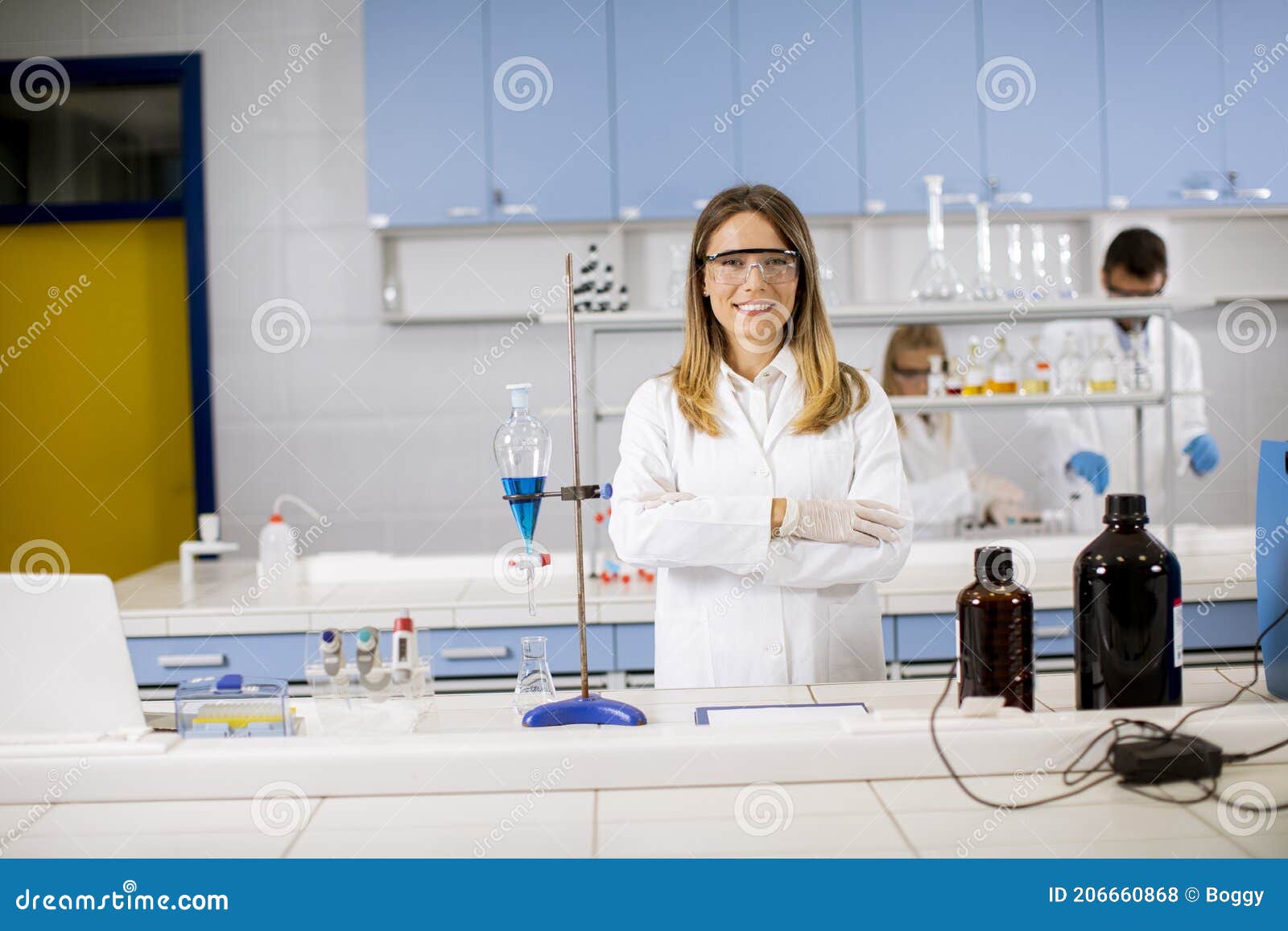 Female Scientist in White Lab Coat Standing in the Biomedical Lab Stock ...