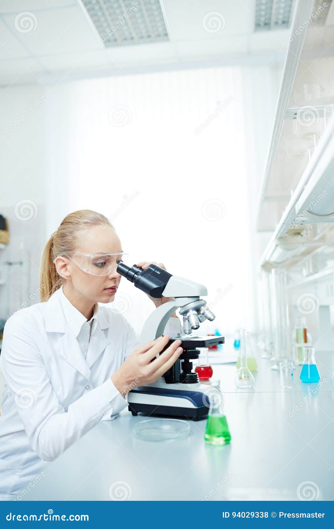 Female Scientist Working in Laboratory with Microscope Stock Photo ...
