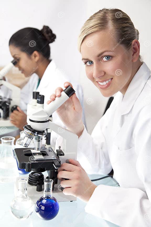 Female Scientists Using Microscopes in Laboratory Stock Image - Image ...