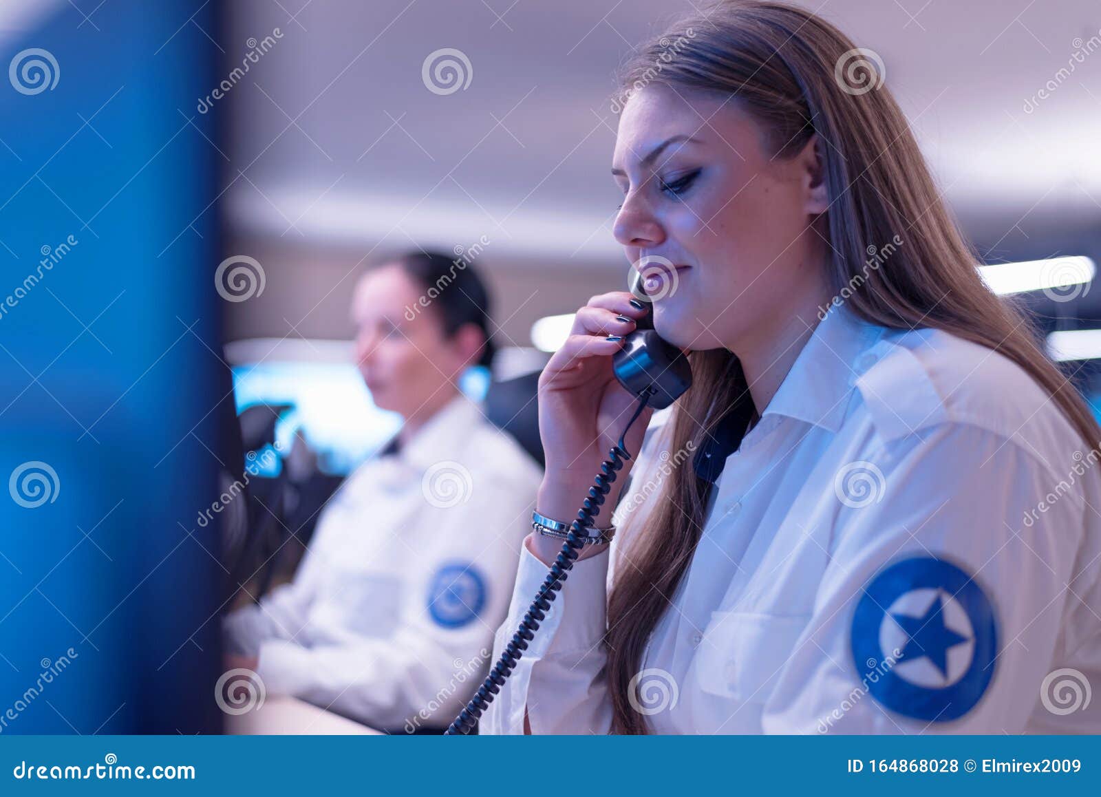 Female Security Guard Operator Talking on the Phone, Calling in the ...