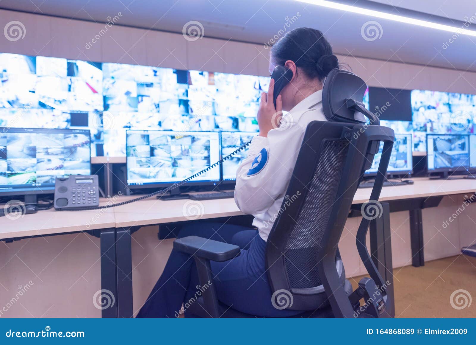 Female Security Guard Operator Talking on the Phone, Calling in the ...