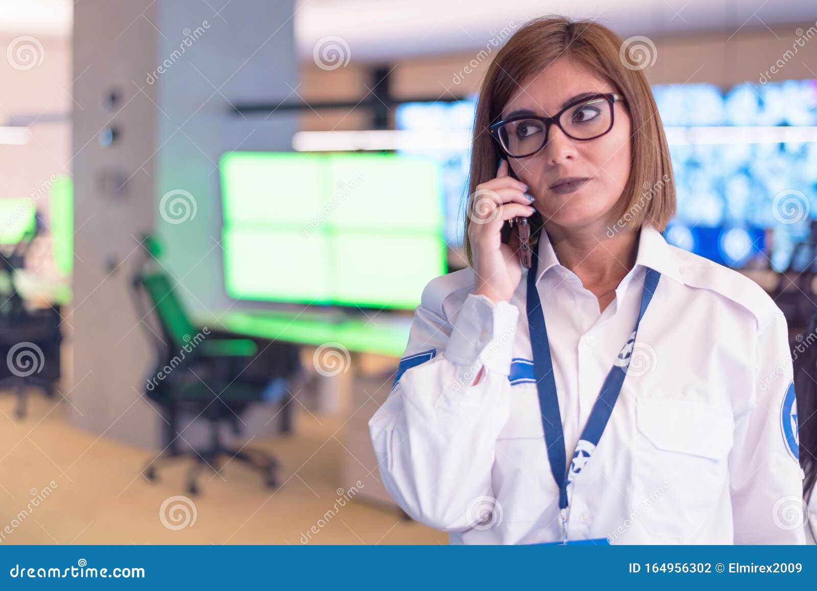 Female Security Guard Operator Talking on the Phone, Calling in the ...