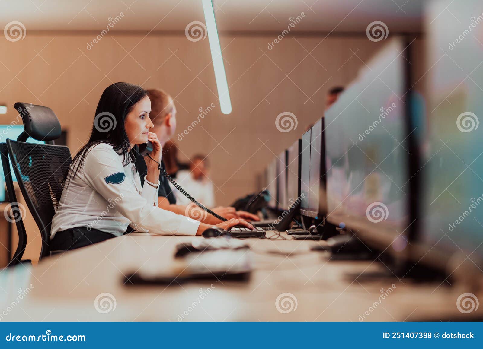 Female Security Guard Operator Talking on the Phone while Working at ...