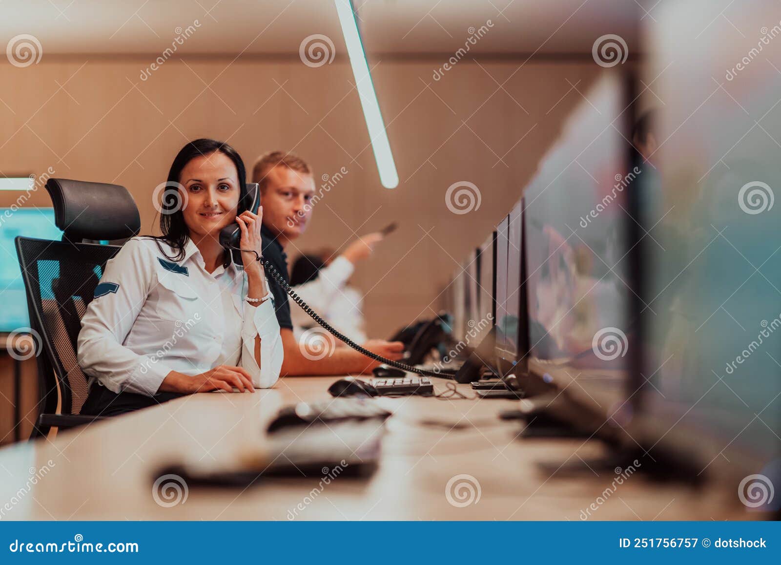 Female Security Guard Operator Talking on the Phone while Working at ...