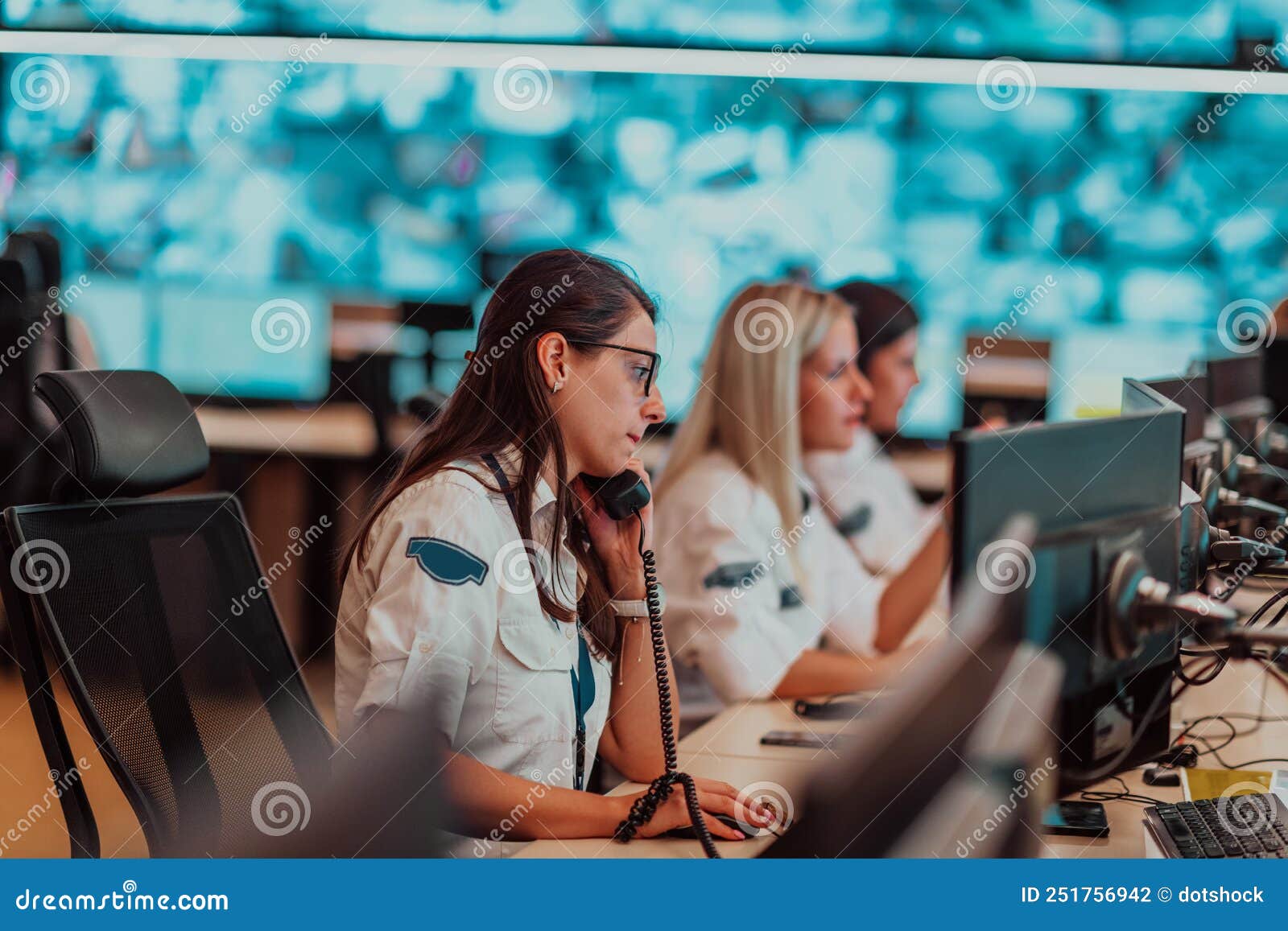 Female Security Guard Operator Talking on the Phone while Working at ...