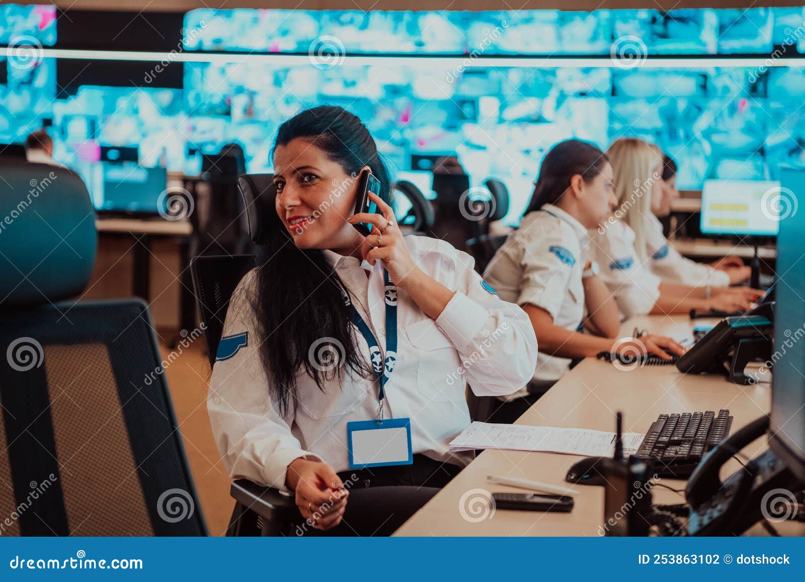 Female Security Guard Operator Talking on the Phone while Working at ...