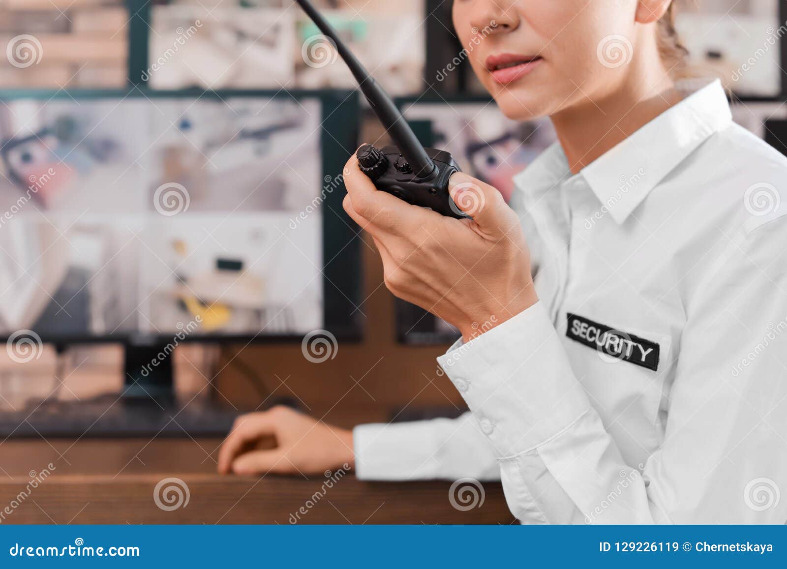 Female Security Guard Operator Talking On The Phone, Calling In The ...